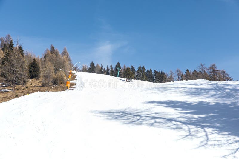Sunny Alpine Ski Slope with Clear Sky and Forested Surroundings Stock ...