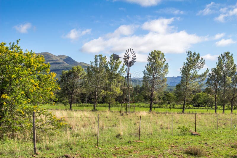 Sunny Farm Field with Wind Pump Stock Image - Image of peaceful, farm ...