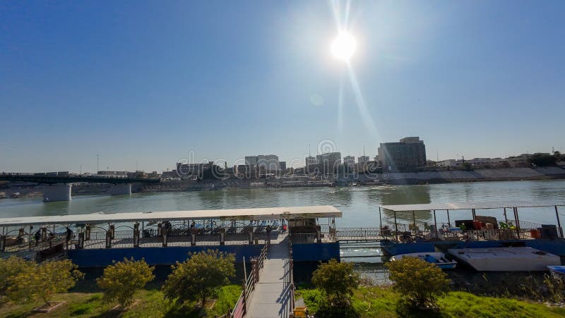 Sunny Riverside with City Skyline Stock Image - Image of reflection ...