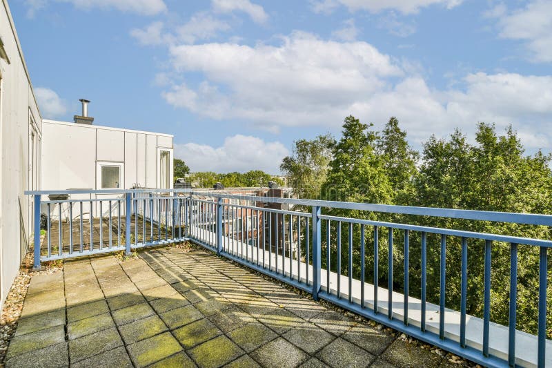 Sunny Rooftop Terrace with Greenery Stock Photo - Image of railings ...