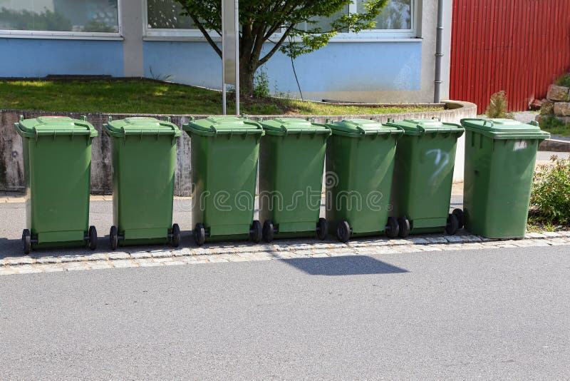 Sunny Scenery of Green Garbage Cans in the Street Stock Image - Image ...