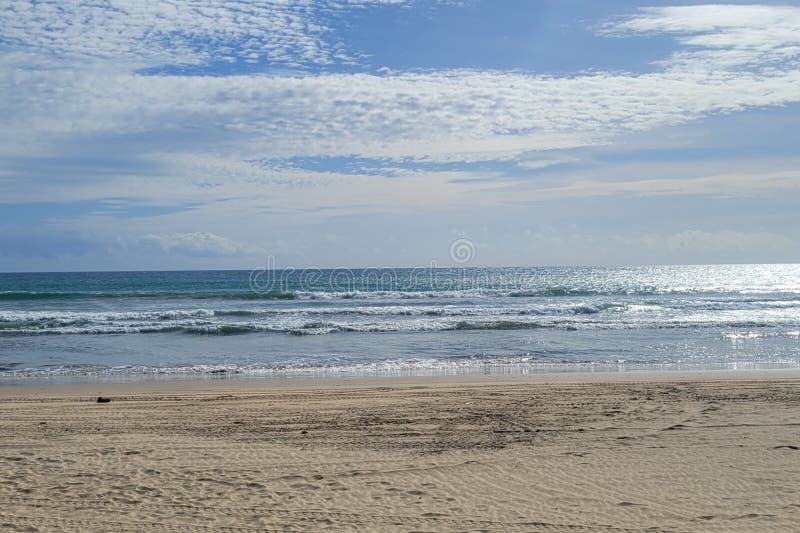 Sunny Seaside View with Blue Water and Sandy Beach Stock Image - Image ...