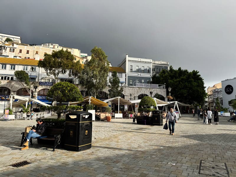 Sunny Square with People and Shops Under a Dramatic Sky in Gibraltar ...