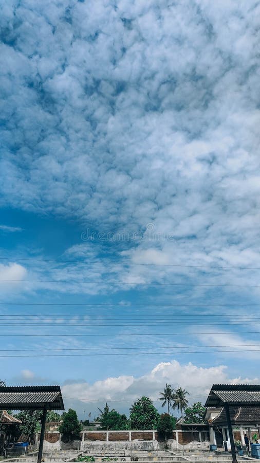Sunny Village Scene with Clear Sky and Clouds Stock Photo - Image of ...