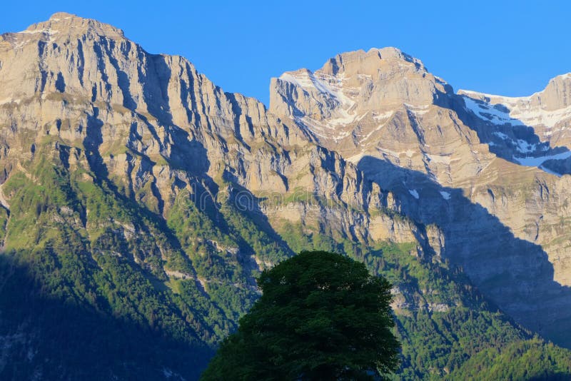 Sunny Wooded Mountain Range with Forests and Rugged Cliffs Stock Photo ...