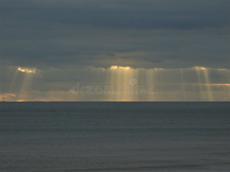 Sunrays through Heavy Clouds on the Beach Stock Photo - Image of cloud ...