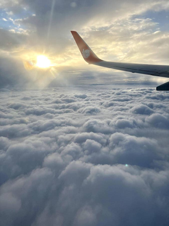 Sunrise Above Clouds from a Plane Window. Beautiful Blue Sky and Fluffy ...