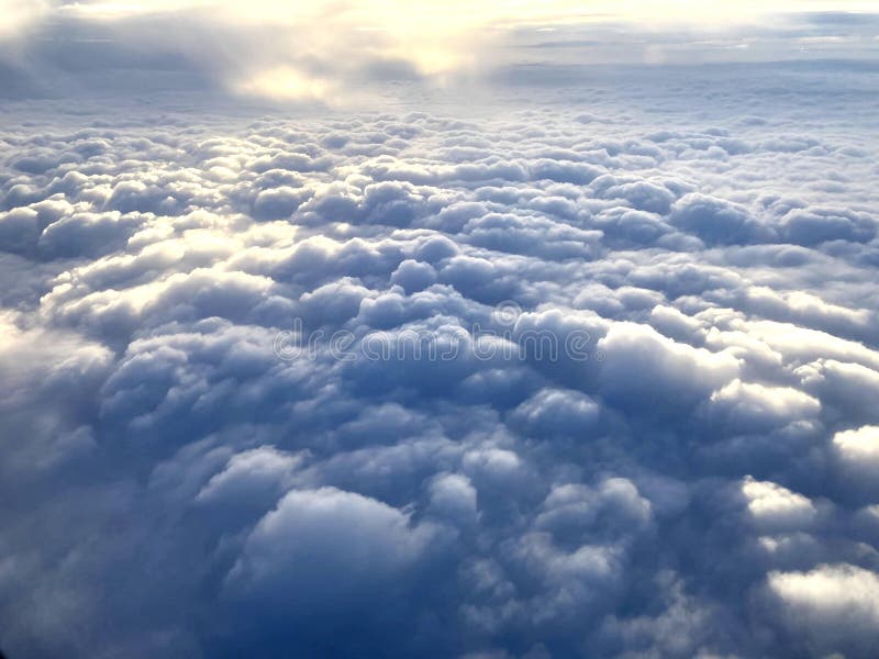 Sunrise Above Clouds from a Plane Window. Beautiful Blue Sky and Fluffy ...