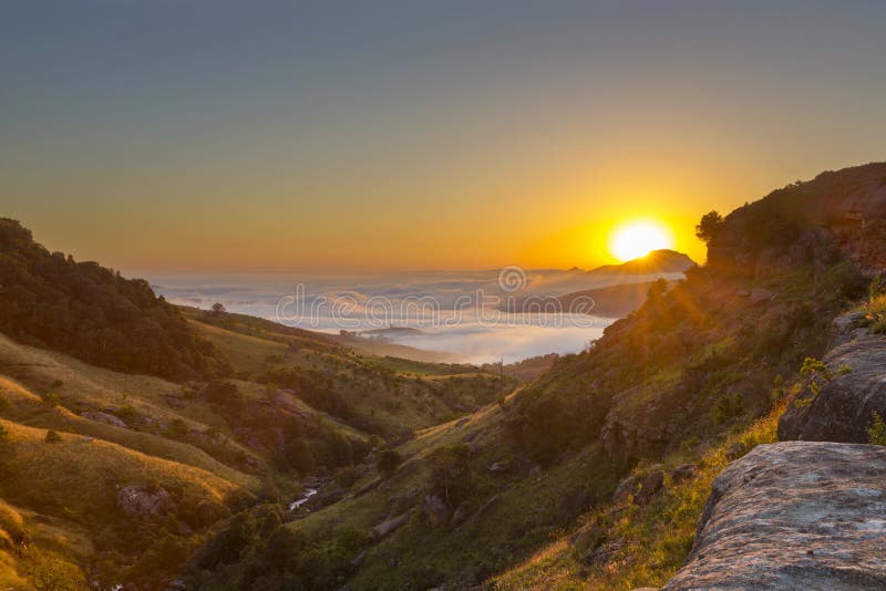 Sunrise Above the Clouds in the Valley Below Stock Photo - Image of ...