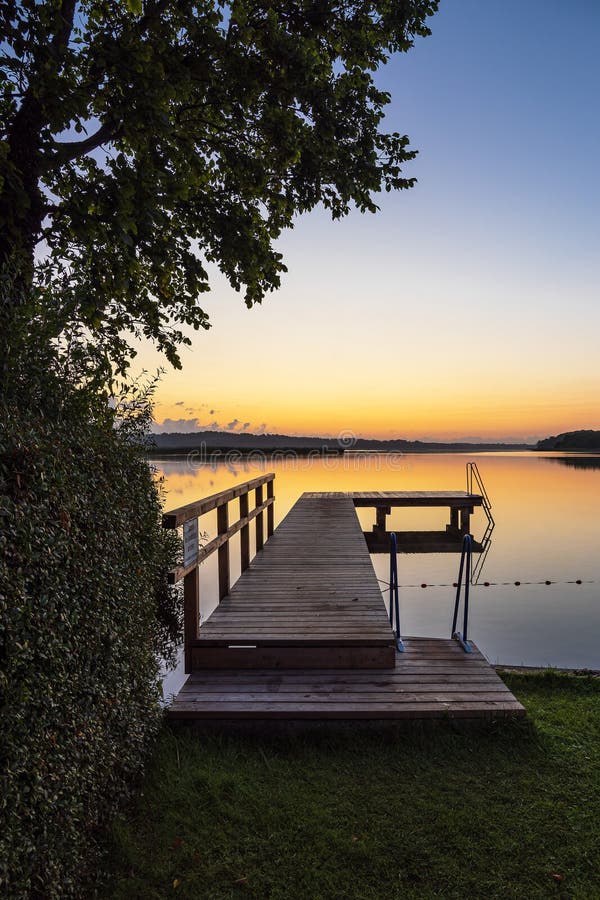 Sunrise with Clouds and Pier at the Lake Schaalsee in Seedorf, Germany ...