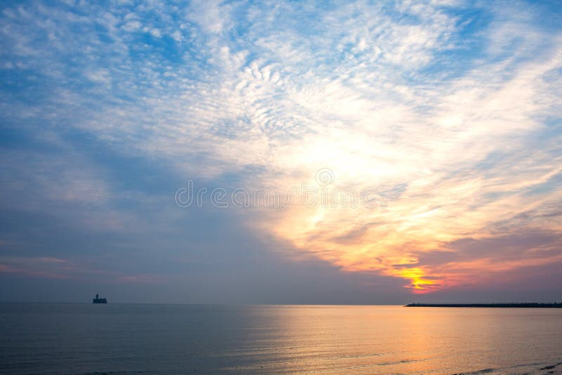 Sunrise in Cloudy Weather Over the Sea without Waves Stock Image ...