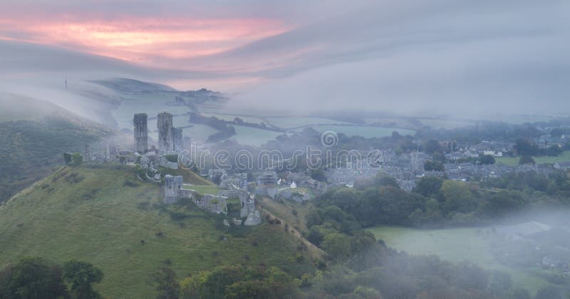 Sunrise at Corfe Castle in Mist Stock Photo - Image of trees, purbeck ...