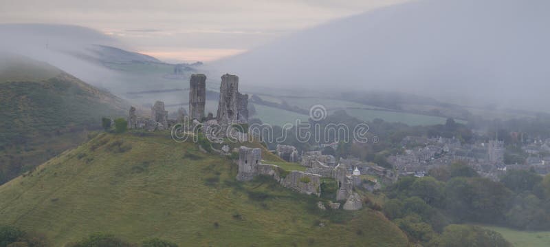 Sunrise at Corfe Castle in Mist Stock Photo - Image of trees, fields ...