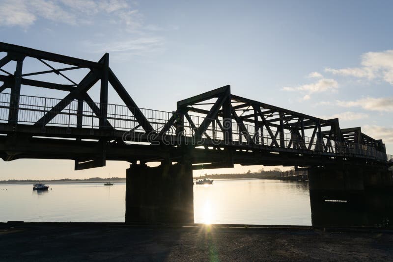 Sunrise Glows through Tauranga Railway Bridge Silhouette Stock Photo ...