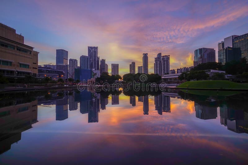 Sunrise at KLCC Lake stock photo. Image of morning, east - 52623538