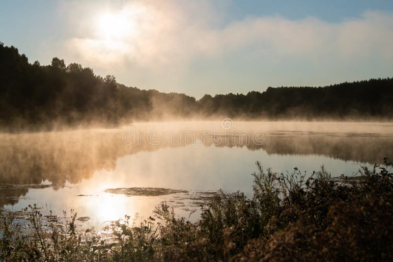 Sunrise and Mist on a Beautiful Lake in the Early Morning. Stock Image ...