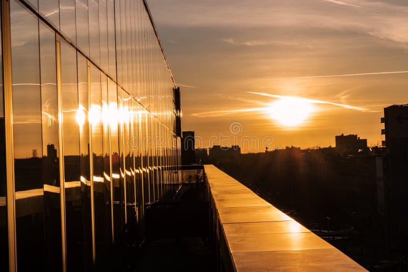 Sunrise Over the City with Reflection from the Glass Facade of the ...