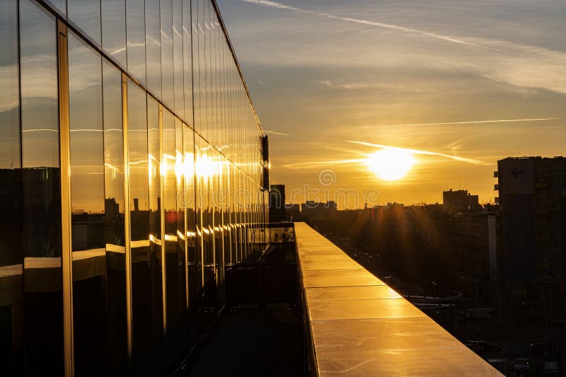 Sunrise Over the City with Reflection from the Glass Facade of the ...