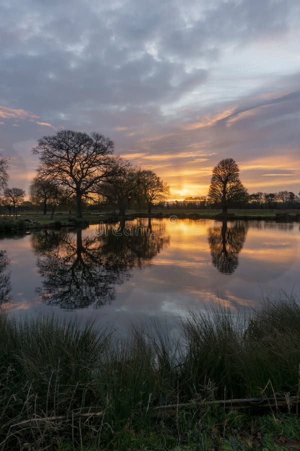 Sunrise Over a Lake with Reflections Stock Image - Image of sunrise ...
