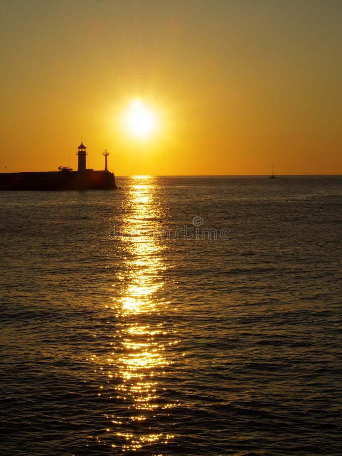 Sunrise Over a Lighthouse in the Sea Stock Image - Image of pier ...