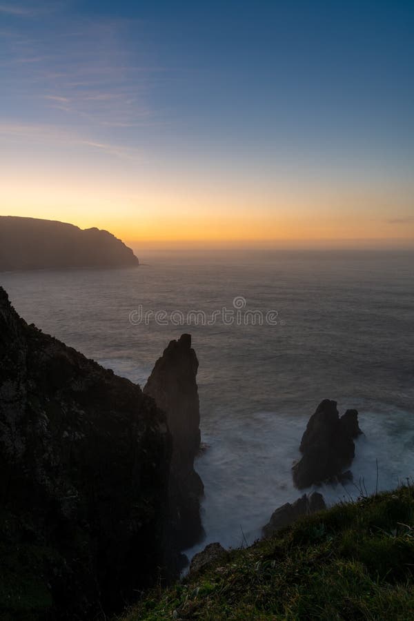 Sunrise Over the Ocean with Cliff in Silhouette and Beautiful Colors ...