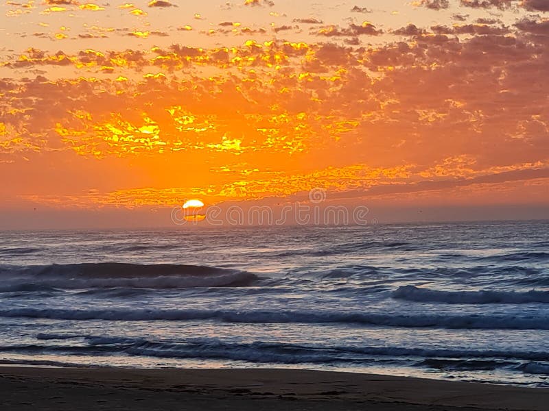 Sunrise Over Ocean with Clouds and Blue Sky Stock Photo - Image of ...
