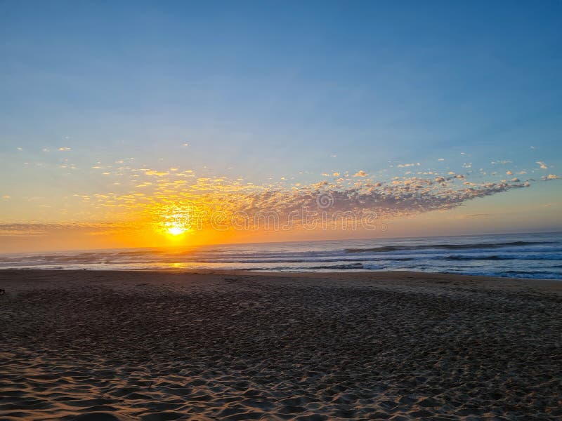 Sunrise Over Ocean with Clouds and Blue Sky Stock Image - Image of ...