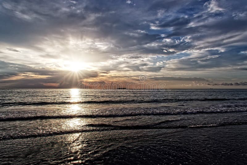 Sunrise Over OCean Sun through Clouds Stock Image - Image of horizon ...