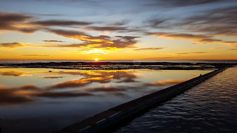 Sunrise over rock pool stock photo. Image of clouds, scenery - 80428188