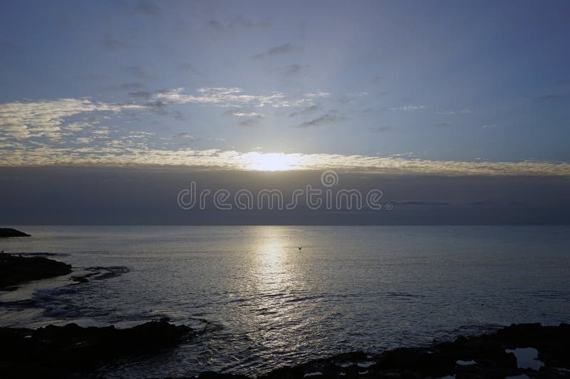 Sunrise Over the Sea. Light Breaks through a Strip of Clouds Stock ...