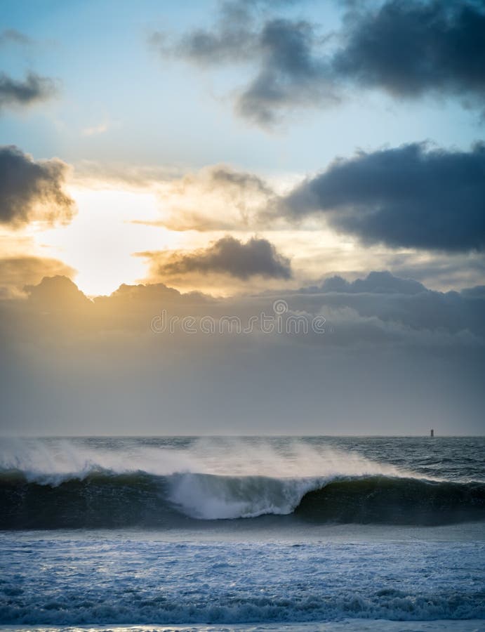 Sunrise Over the Sea during a Storm with Dramatic Clouds and Sunlight ...