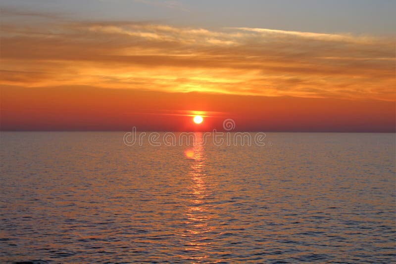 Sunrise Over the Sea with the Sun Rising Over the Horizon Stock Image ...