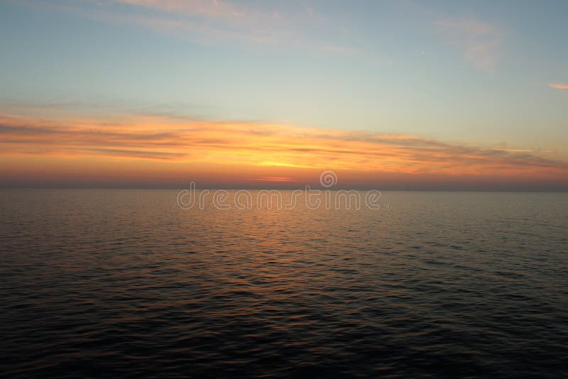 Sunrise Over the Sea with the Sun Rising Over the Horizon Stock Photo ...