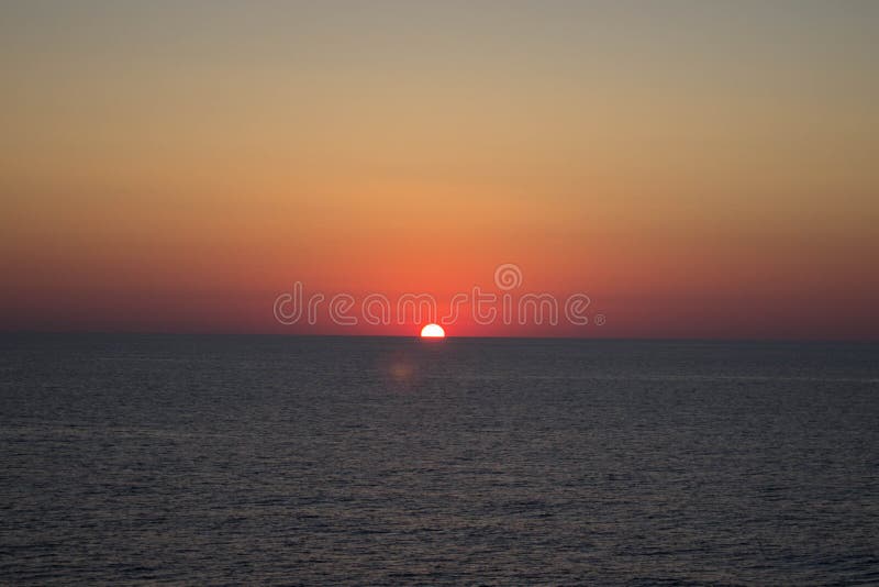 Sunrise Over the Sea with the Sun Rising Over the Horizon Stock Image ...
