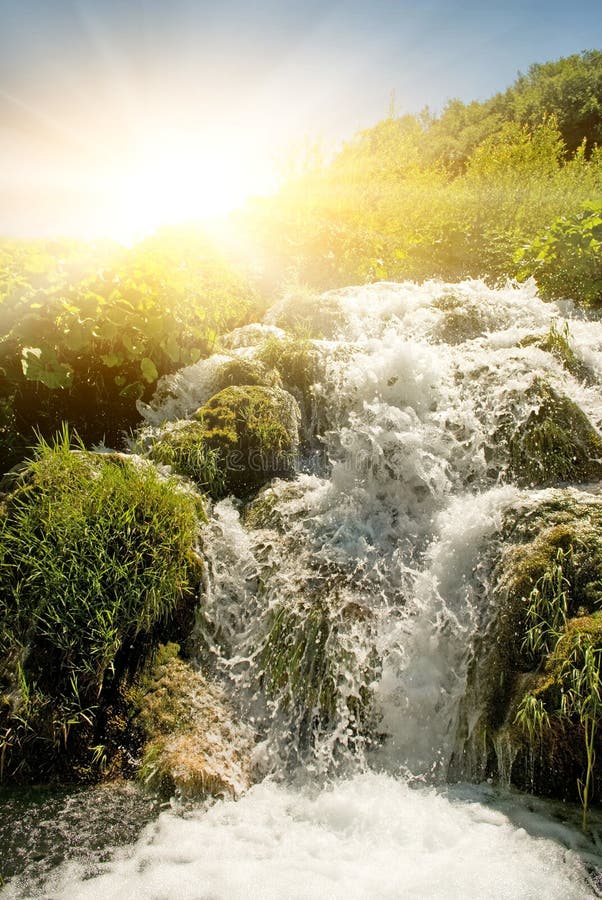 Sunrise over waterfall stock photo. Image of beams, forest - 7731540