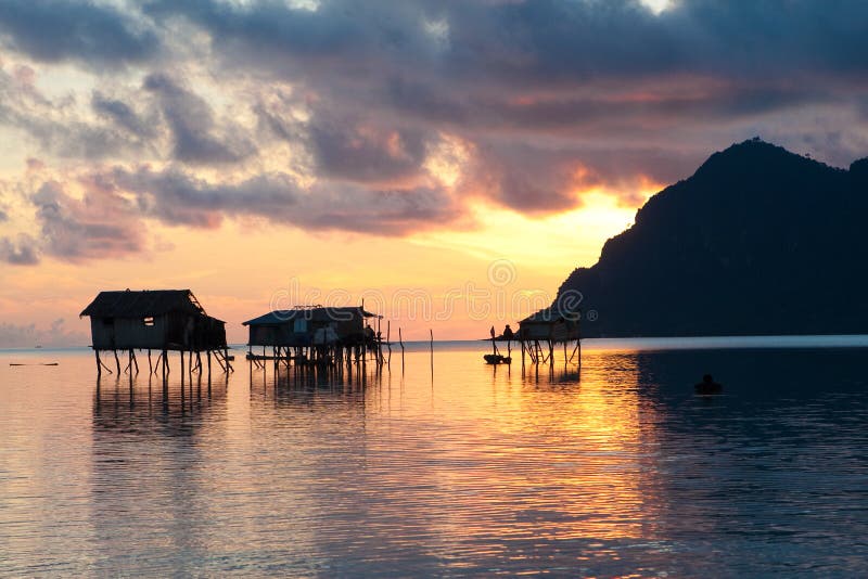 Sunrise Over Wooden Homes on Stilts Stock Image - Image of grove ...