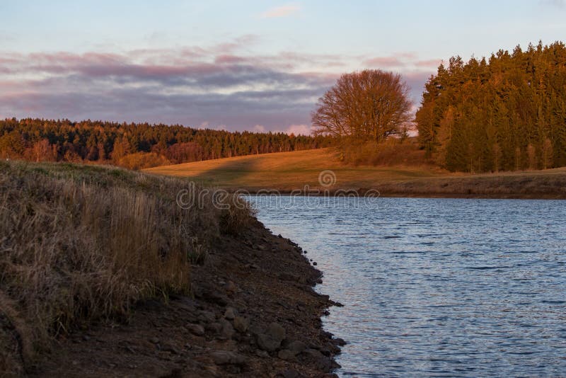 Sunrise by the River Bank with the View on a Medow and Forest Stock ...