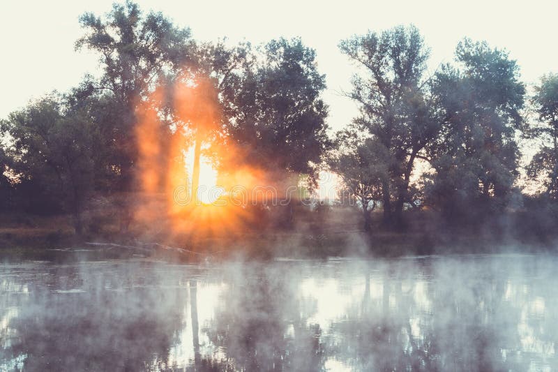 Sunrise on a River with a Mist Over the Water Stock Photo - Image of ...