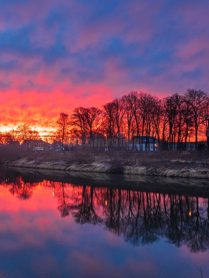 Sunrise on the River. the Sky is Red and Orange. Reflection in the ...