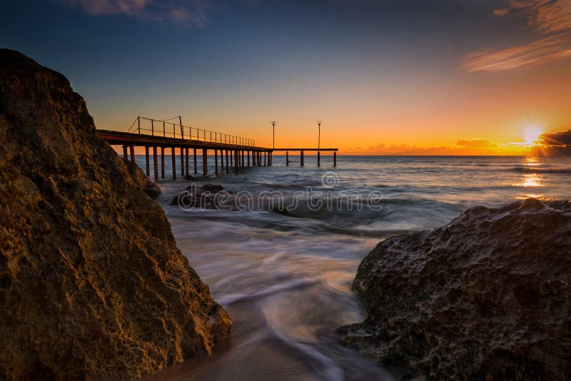 Sunrise between Rocks on the Bay Stock Photo - Image of dramatic ...
