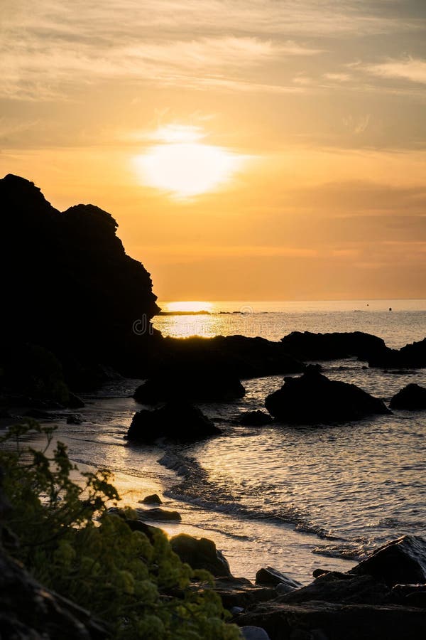 Sunrise between Rocks and Water at Benalmadena Beach Stock Image ...