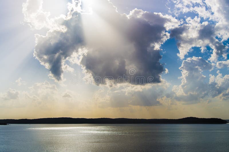 Sunrise / Sunset Light Rays Over Lake Stock Photo - Image of cloud ...