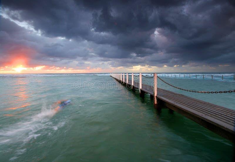 Sunrise Swim with Storm Clouds Stock Image - Image of beautiful, flow ...