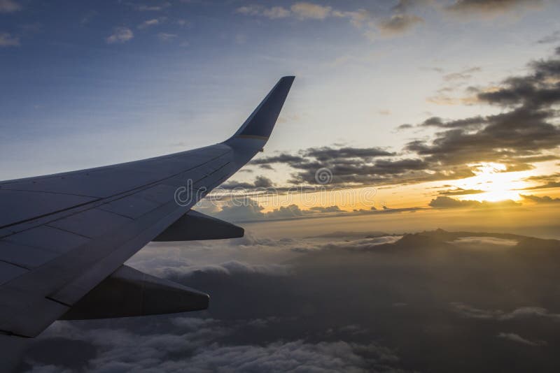 Sunrise from a Plane in Flight with the View of Its Wing and the Sun ...