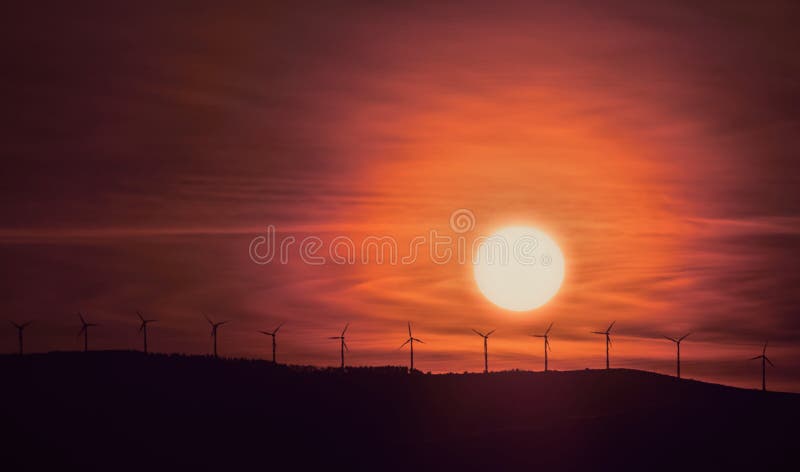 Sunrise with Wind Turbines on the Hill and Sun and Clouds in the ...