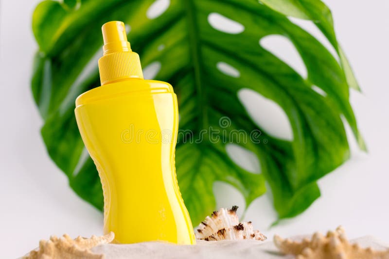 Sunscreen Spray Bottle on a Sandy Beach with Different Seashells ...