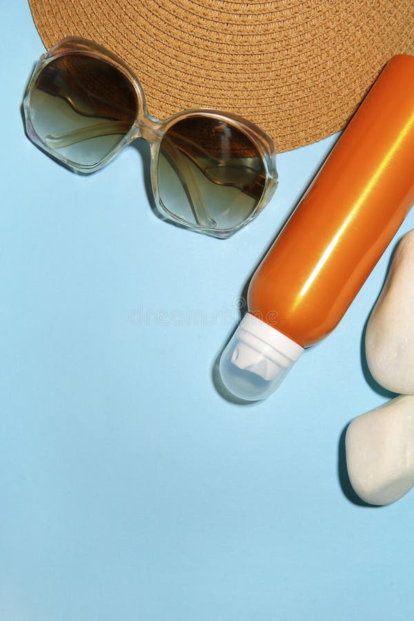 Sunscreen, Stones and Beach Accessories on Light Blue Background, Flat ...