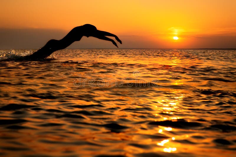 Swimmer in sunset stock photo. Image of holiday, concept - 75886836