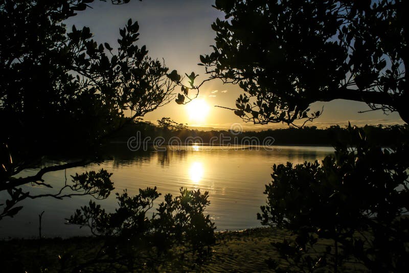 Sunset across lake stock image. Image of light, scenic - 55674171