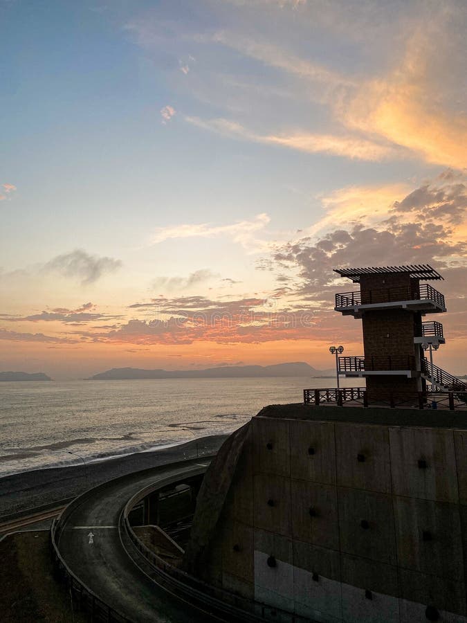 Sunset Beach Behind the Tower and the Lightin Clouds Stock Image ...